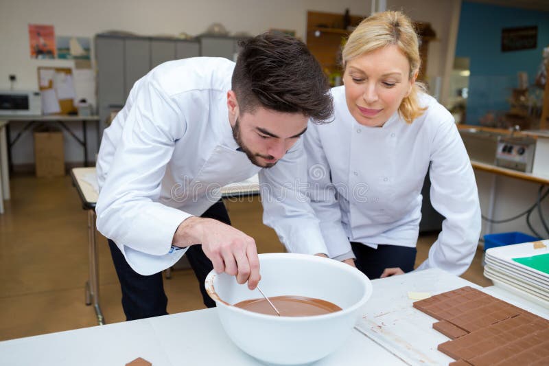 Chocolatier Apprentice Mixing Melted Chocolate Stock Image - Image of working, brand: 319214863