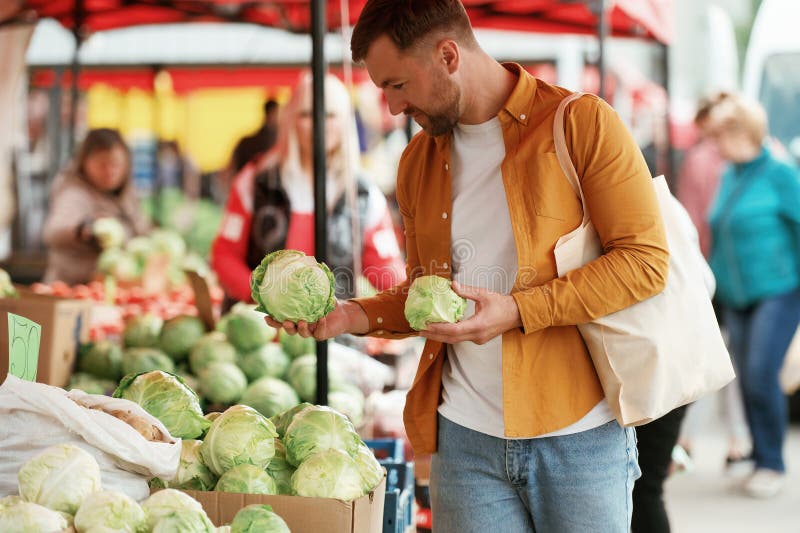 Choosing Cabbage. Handsome Man is on the Street Market or Bazaar Stock ...