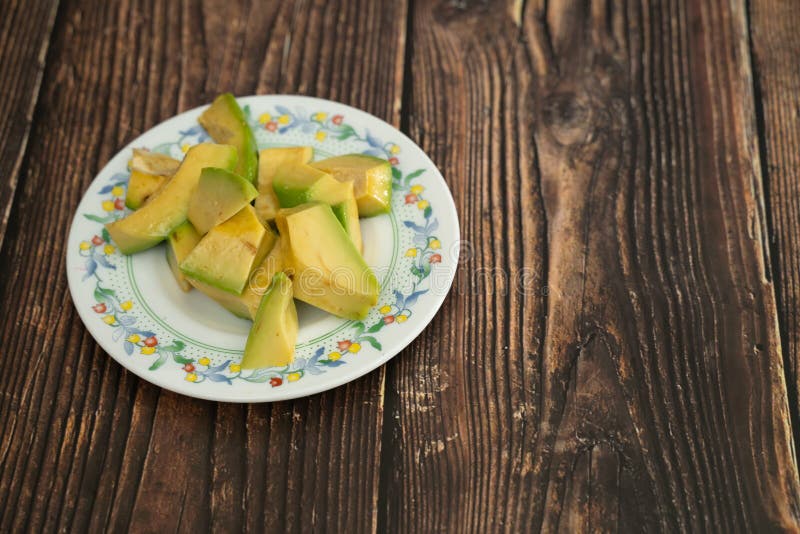 Chopped Avocado on a Plate on a Wooden Background Stock Image - Image ...