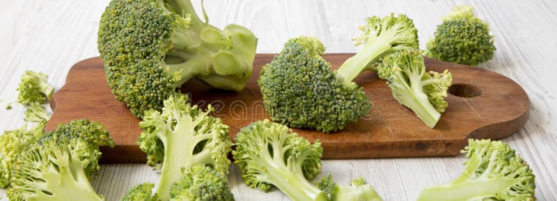 Chopped Broccoli on a Rustic Wooden Cutting Board on White Wooden ...