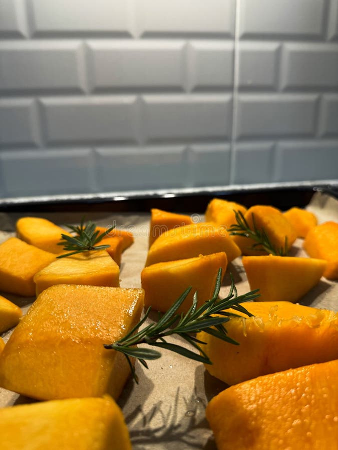 Chopped Butternut Squash with Fresh Rosemary Ready for Roasting on a ...