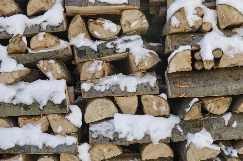 Chopped Firewood on a Stack in Snow. Front View Stock Photo - Image of ...