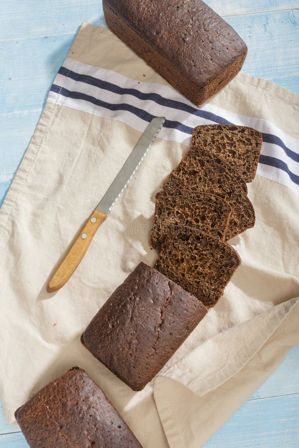Chopped Loaf Rye Bread on Wooden Blue Surface, Top View Stock Photo ...