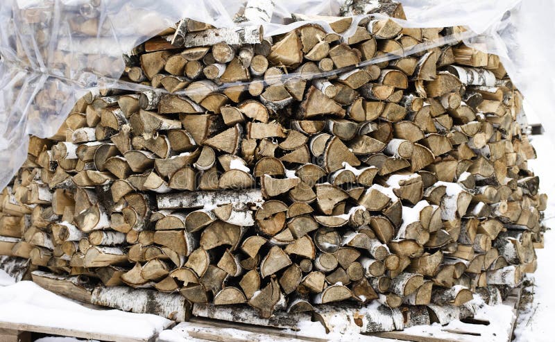 Chopped Stack of Firewood Under Snow. Preparation of Firewood for the ...