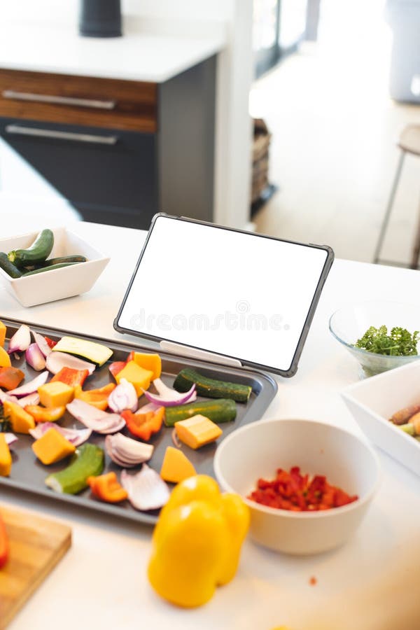 Chopped Vegetables in Backing Tray and Tablet with Copy Space Screen on ...