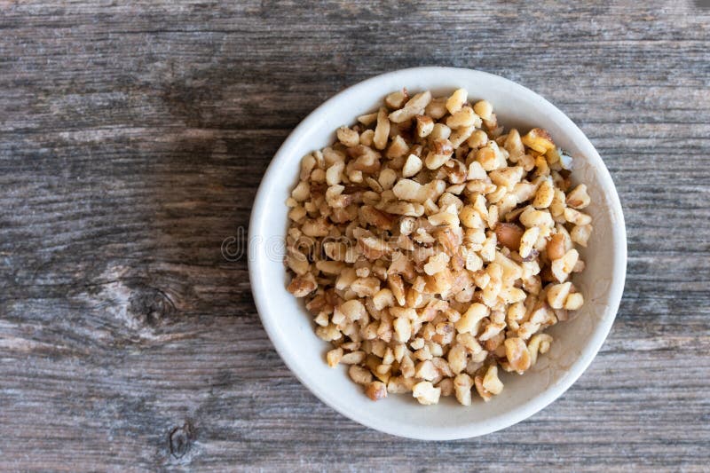 Chopped Walnuts in a Bowl stock photo. Image of isolated - 193887996
