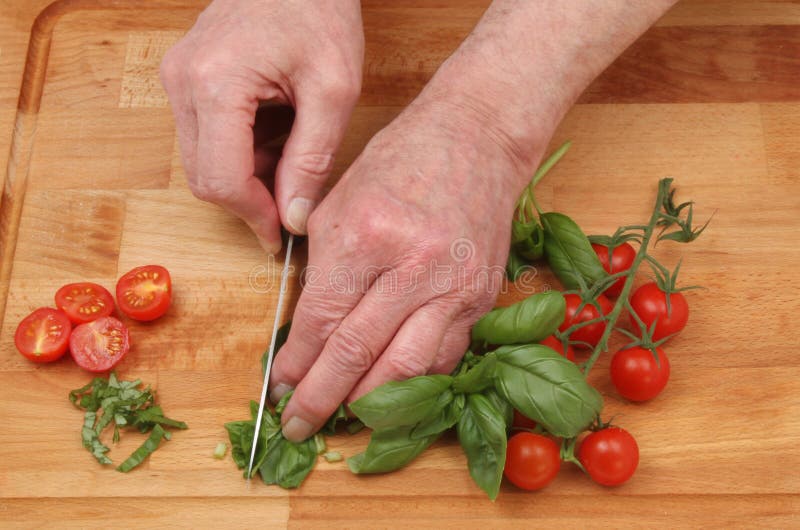 Chopping basil and tomato stock photo. Image of basil - 74956142