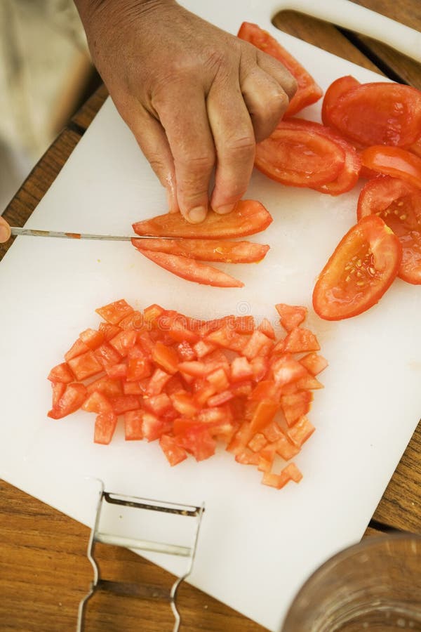 Chopping the tomatoes stock image. Image of step, people - 23707053
