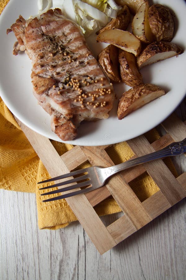 Chops and potato on plate stock image. Image of gourmet - 65214043