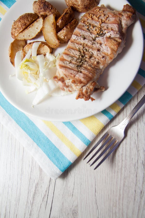 Chops and potato on plate stock image. Image of ribs - 65216649