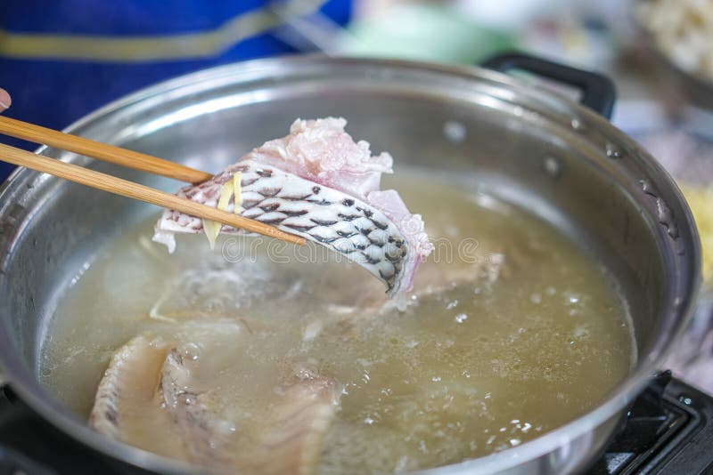 Chopsticks Tong Slice of Fish, Dip Thin Slices of Meat in Boiling Water ...
