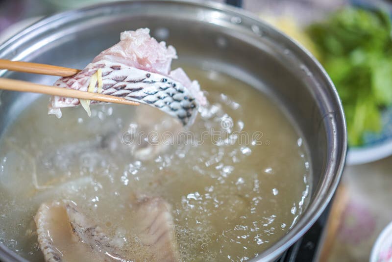 Chopsticks Tong Slice of Fish, Dip Thin Slices of Meat in Boiling Water ...