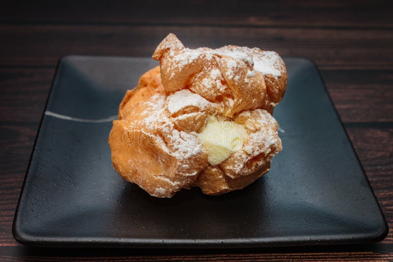 Choux Cream Filled Vanilla Custard and Dusted with Icing Stock Photo ...