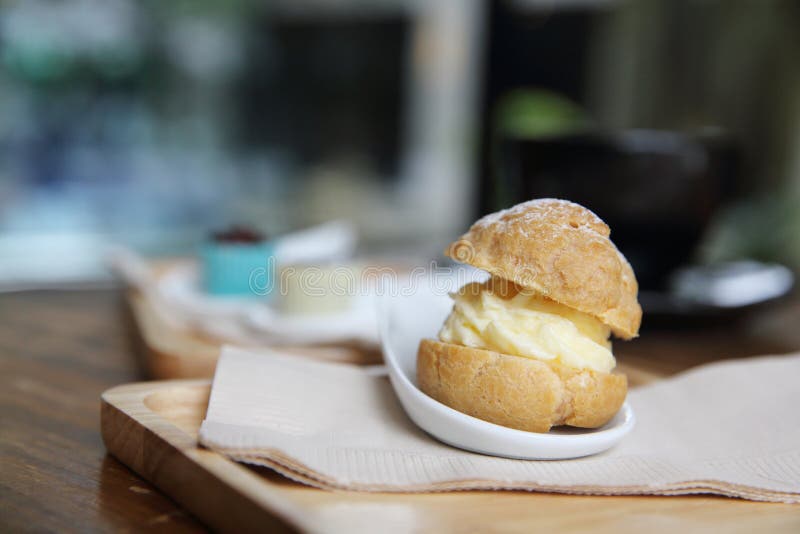 Choux Cream on Wooden Plate Stock Image - Image of powdered, closeup ...