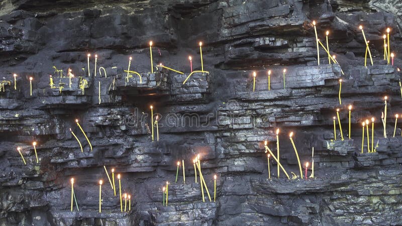 Candles in grotto stock footage. Video of catholicism - 318021268