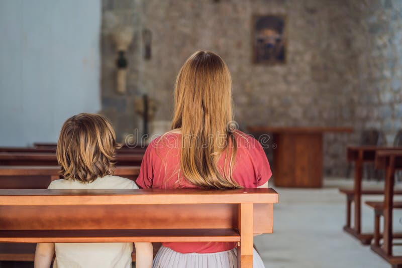 A Christian Mom Tells Her Son Bible Stories About Jesus Sitting In
