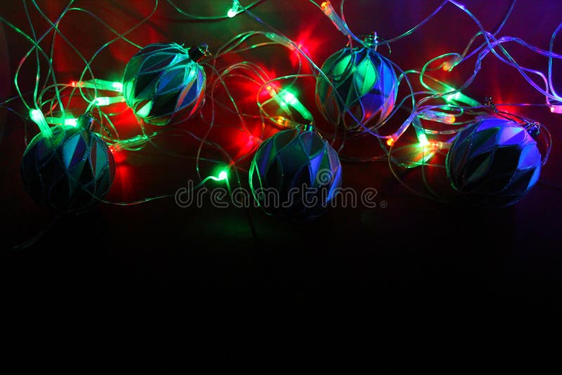 Christmas Balls and Lights Glow in Different Colors on a Black ...