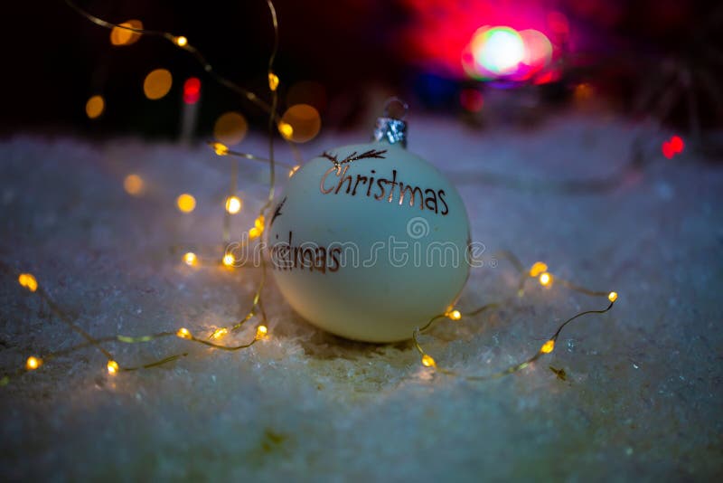 Christmas Balls in the Snow with Lights Stock Photo - Image of ornament ...