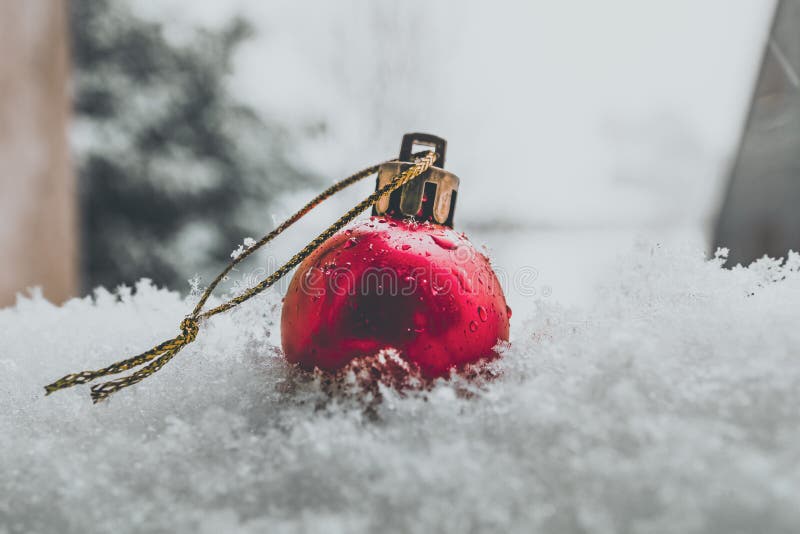 Christmas Bauble in the Snow, Single Red Bauble Stock Image - Image of ...