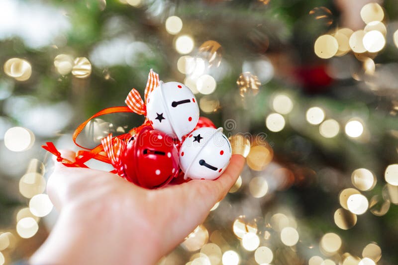 Christmas Bells in Hand.Christmas Tree Decoration with Bells. White and ...