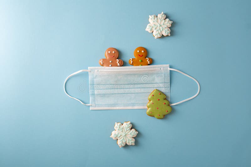 Christmas Concept with Two Gingerbread Man and Face Mask on Blue ...