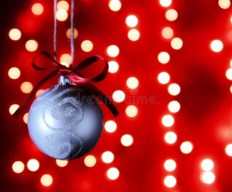 Christmas Decoration Hanging from a String in Front of Festive Lights ...