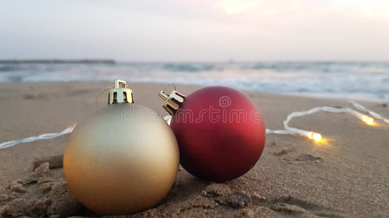 Christmas Decorations in the Form of a Golden and Red Ball on the Sand ...
