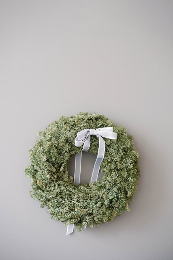 Christmas Decorative Wreath with a Gray Bow on the Background of a Gray ...