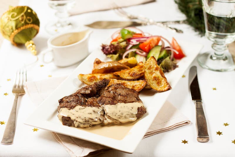 Christmas Dinner. Beef Steak with Roasted Potatoes Stock Image - Image ...