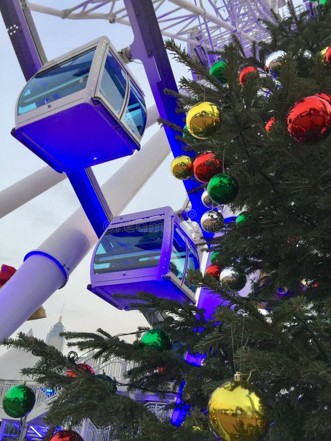 View Beyond Carousel with Reindeers on Christmas Tree and Ferris Wheel ...