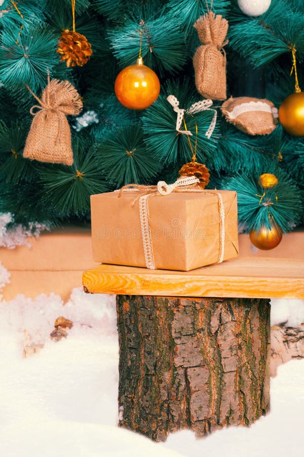 Christmas Gift on a Tree Stump Stock Photo - Image of merry, happy ...
