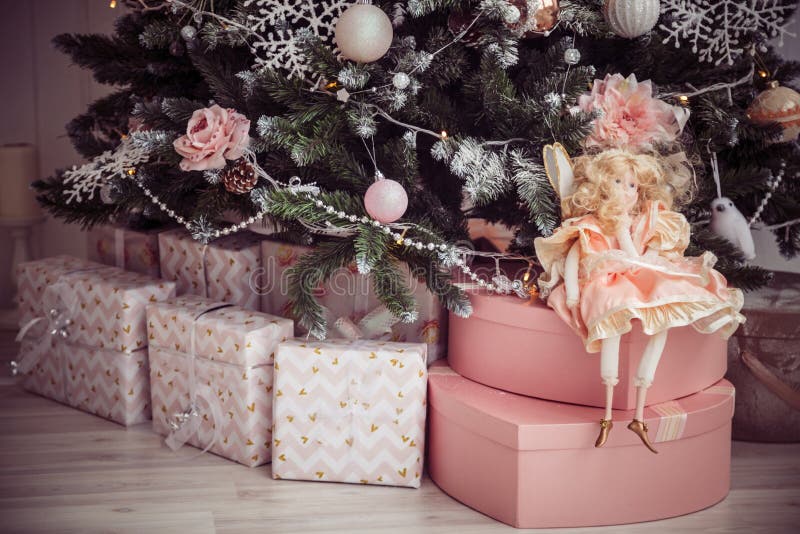 Christmas Gifts and Doll Under the Tree. Pink Decoration. Stock Image ...