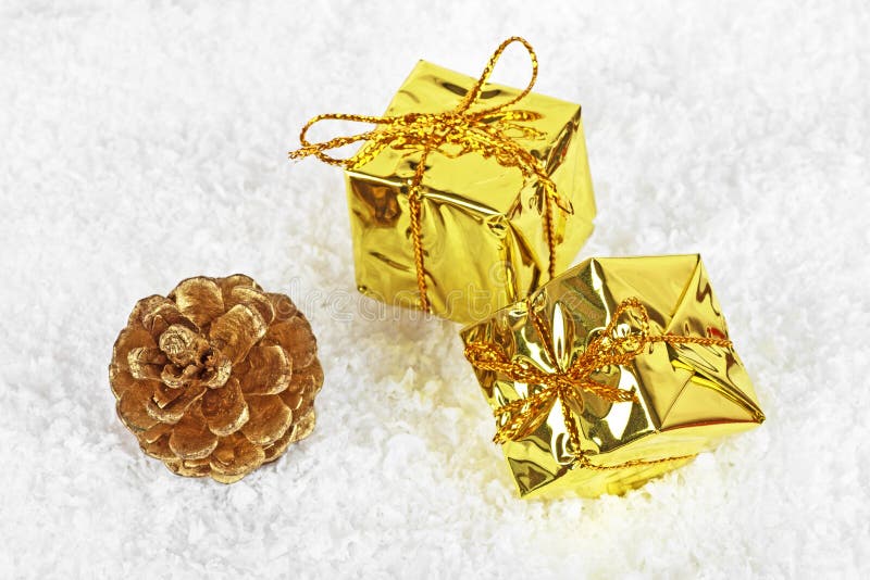 Christmas Gold Boxes and Golden Pine Cone in the Snow Stock Photo ...