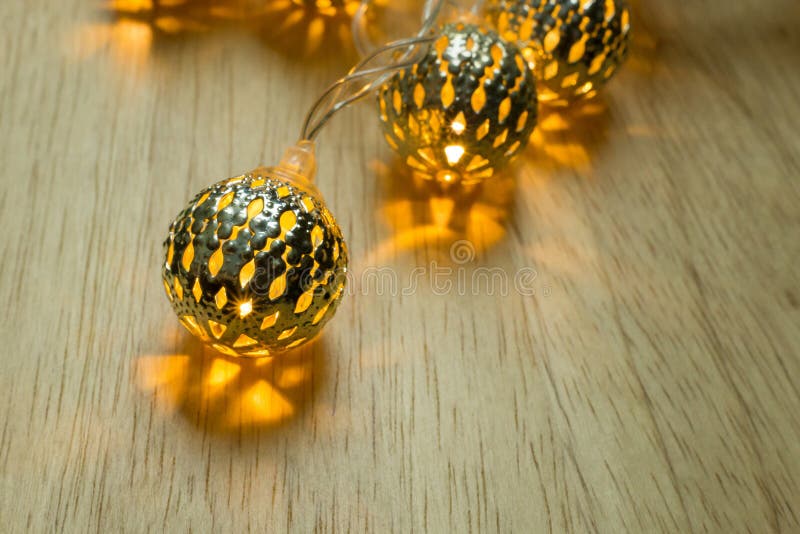 Christmas Gold Lights Ball Decor on Wood Table. Stock Photo - Image of ...
