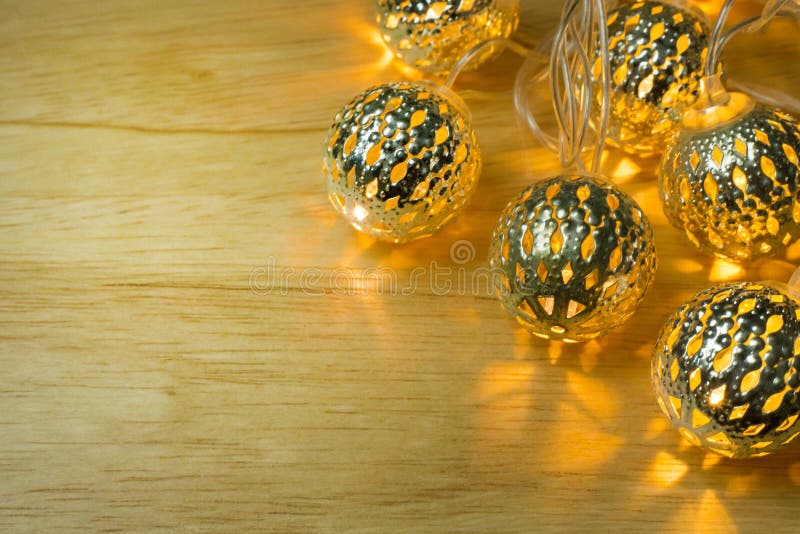 Christmas Gold Lights Ball Decor on Wood Table. Stock Photo - Image of ...