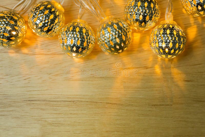 Christmas Gold Lights Ball Decor on Wood Table. Stock Image - Image of ...