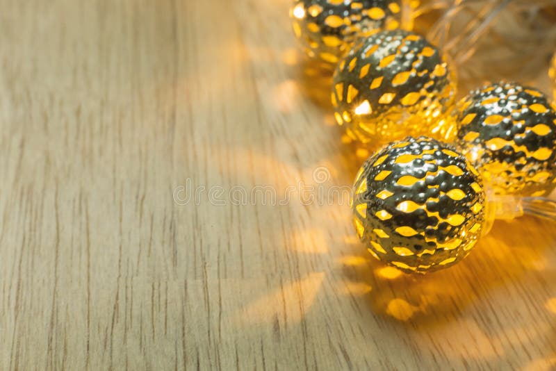 Christmas Gold Lights Ball Decor on Wood Table. Stock Image - Image of ...