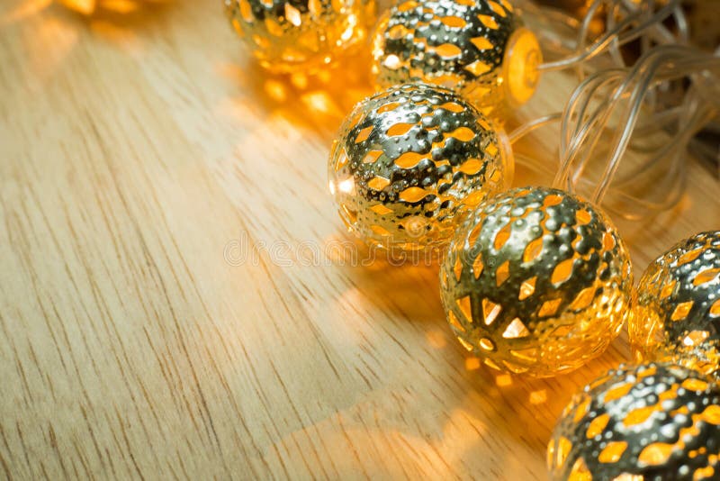 Christmas Gold Lights Ball Decor on Wood Table. Stock Photo - Image of ...