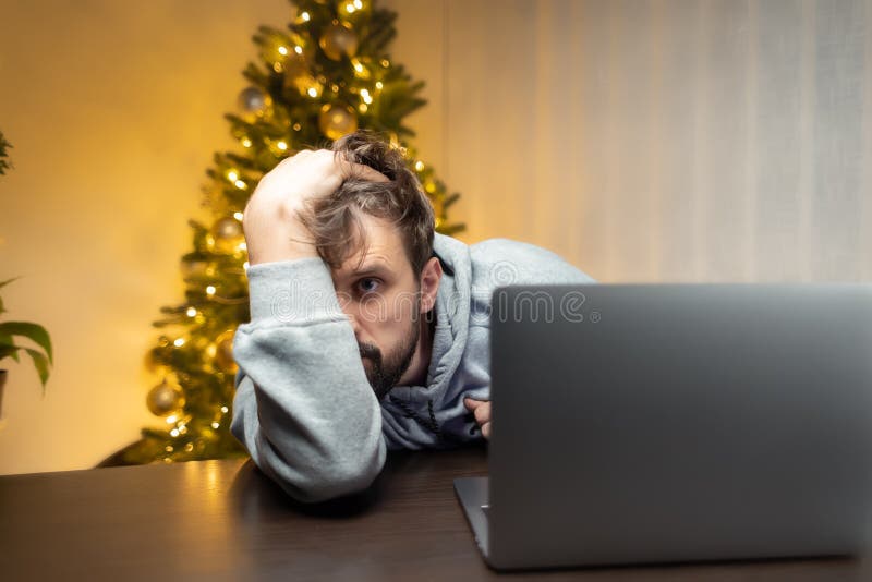 On Christmas Night, a Man Bent Over a Computer, Tired from Work Stock ...