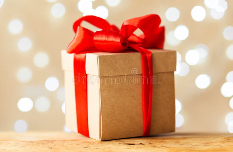 Christmas Present with Decorative Red Ribbon. Bokeh on Background Stock ...