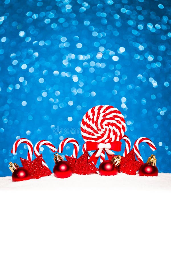 Christmas Red Balls and Candy in Snow on Blue Stock Image - Image of ...