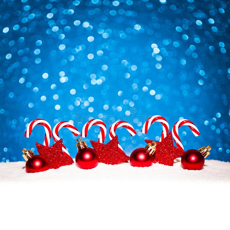 Christmas Red Balls and Candy in Snow on Blue Stock Image - Image of ...