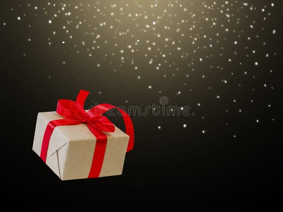 Christmas Snow Falling on a Gift Box with a Red Bow Stock Photo - Image ...