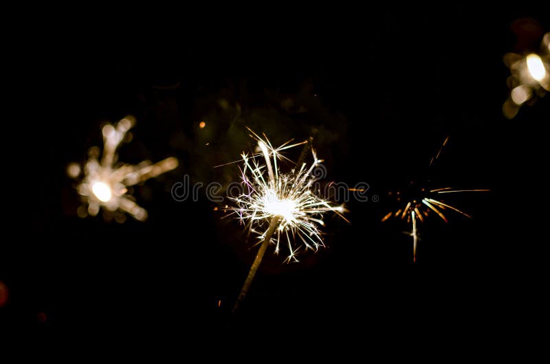 Christmas Sparklers Shining in the Dark. Stock Image - Image of ...