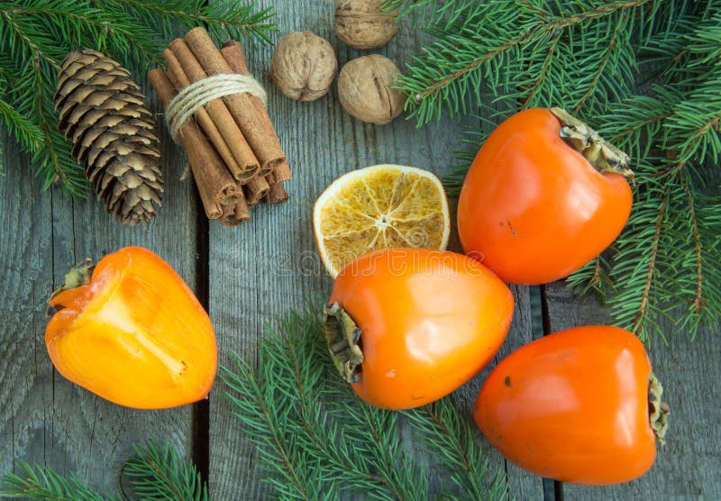 Christmas Still Life of Persimmon on Wooden Table. Stock Photo - Image ...