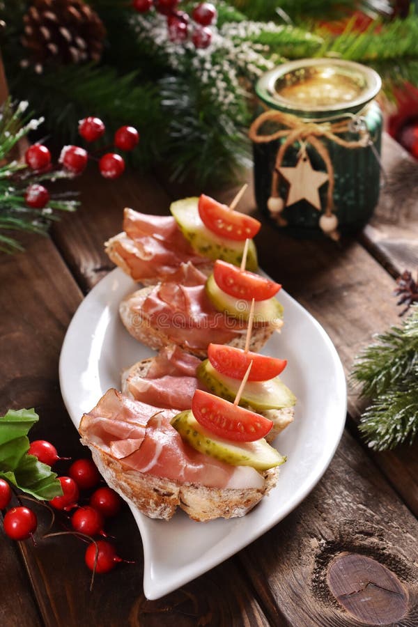 Christmas Table with Mini Canapes with Parma Ham and Pickled Cucumber ...