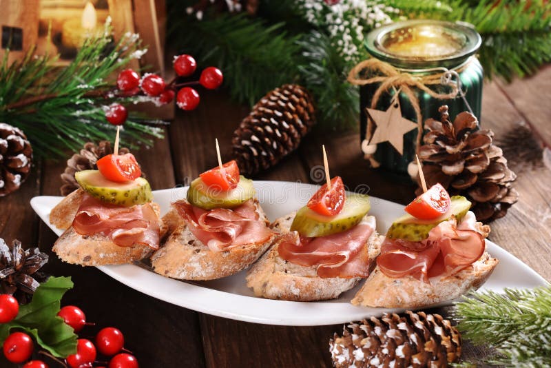 Christmas Table with Mini Canapes with Parma Ham and Pickled Cucumber ...