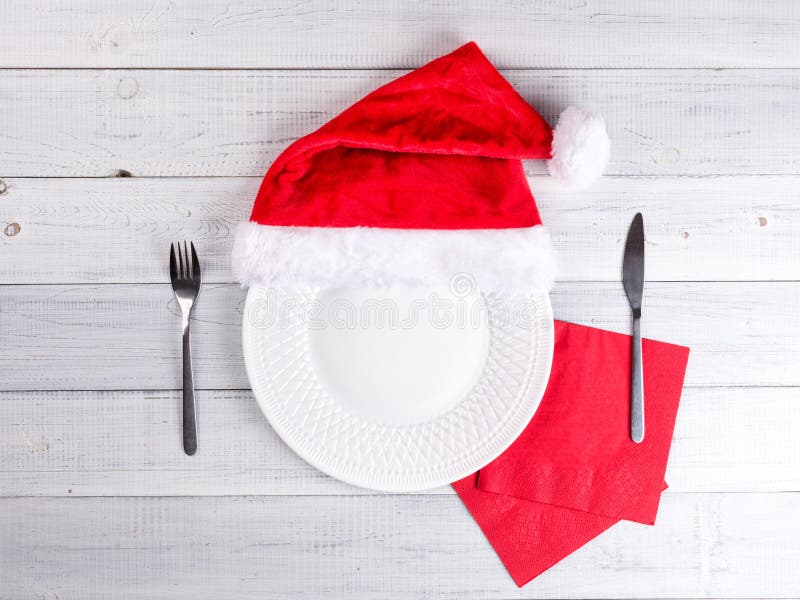 Christmas Table Setting with an Empty Plate and Red Santa Hat Stock ...