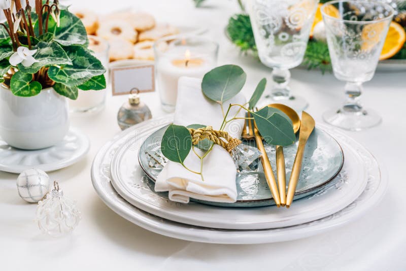 Christmas Table Setting with Eucalyptus, Cutlery and Potted Cyclamen in ...