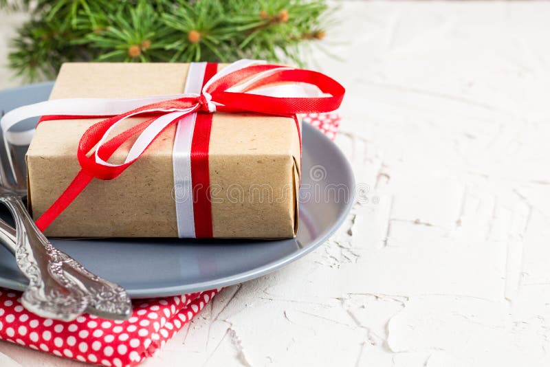 Christmas Table Setting with Gift on Plate on White Table. Xmas Concept ...
